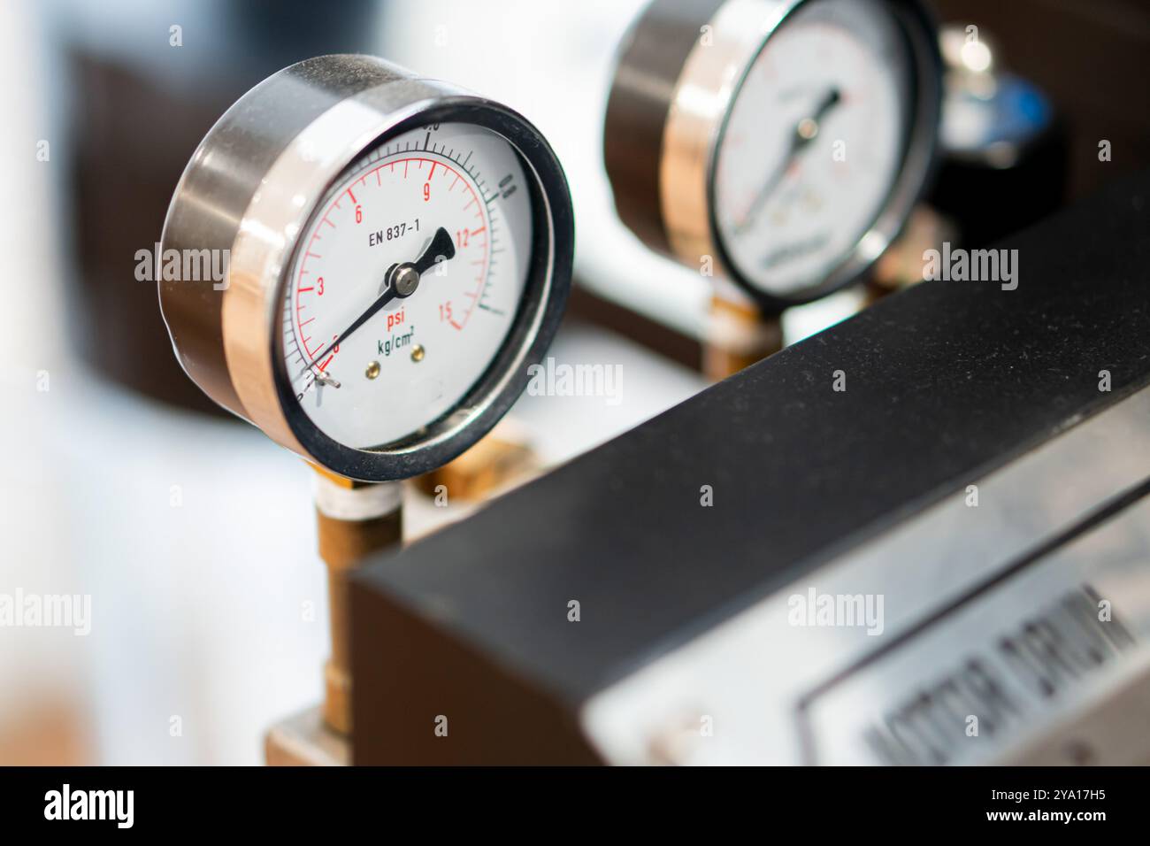 Close-up of pressure gauges on a machine, showing measurements in psi ...