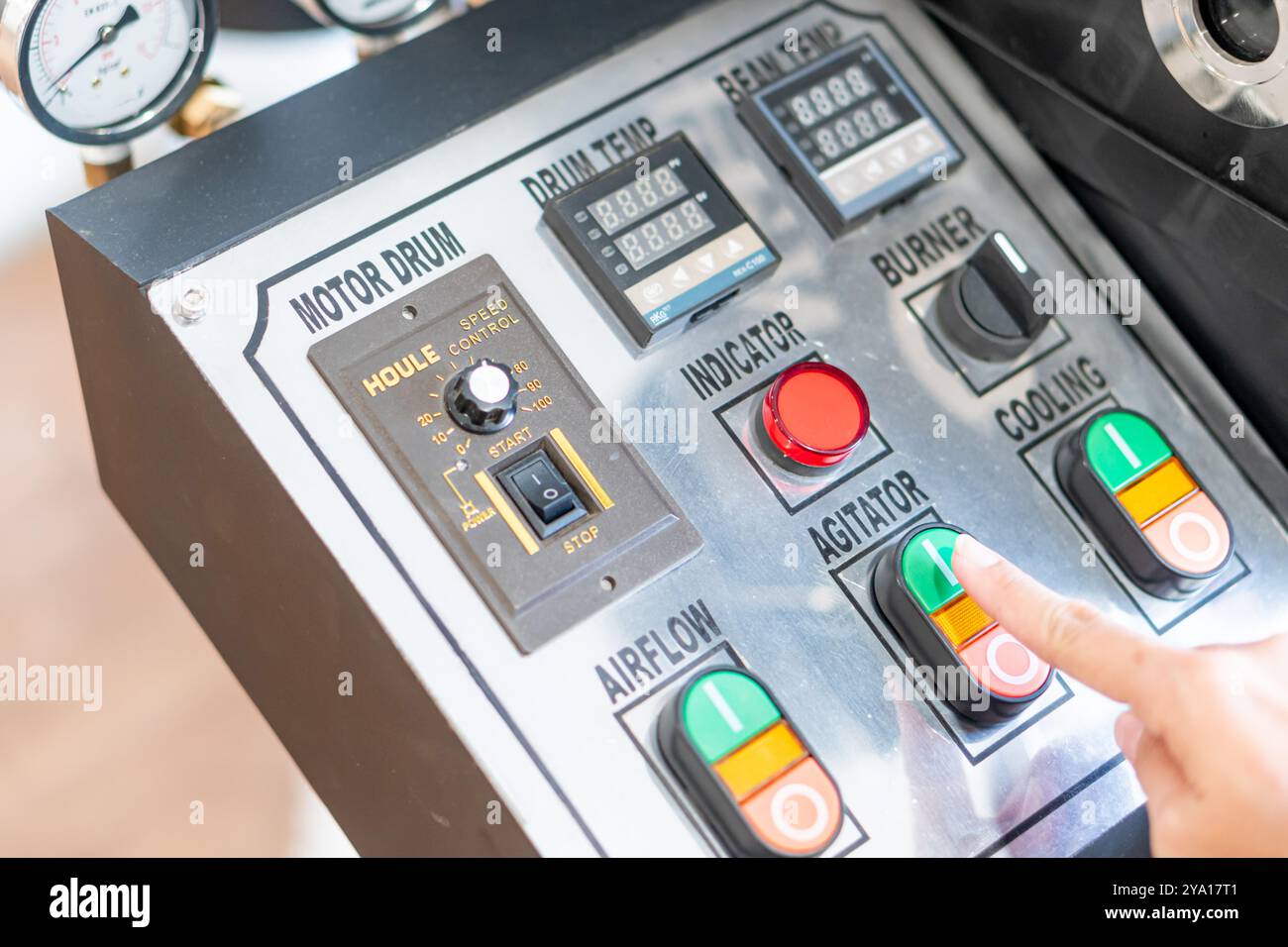A close-up view of a control panel featuring various buttons and gauges. The panel includes ...