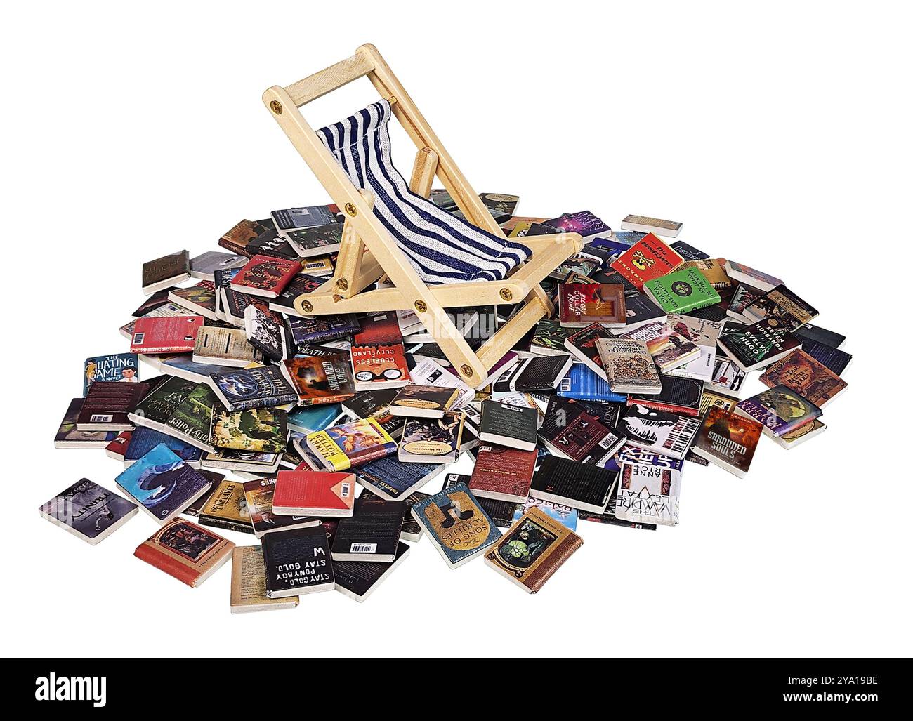 Folding beach chair for easy seating at the beach on a pile of books ...