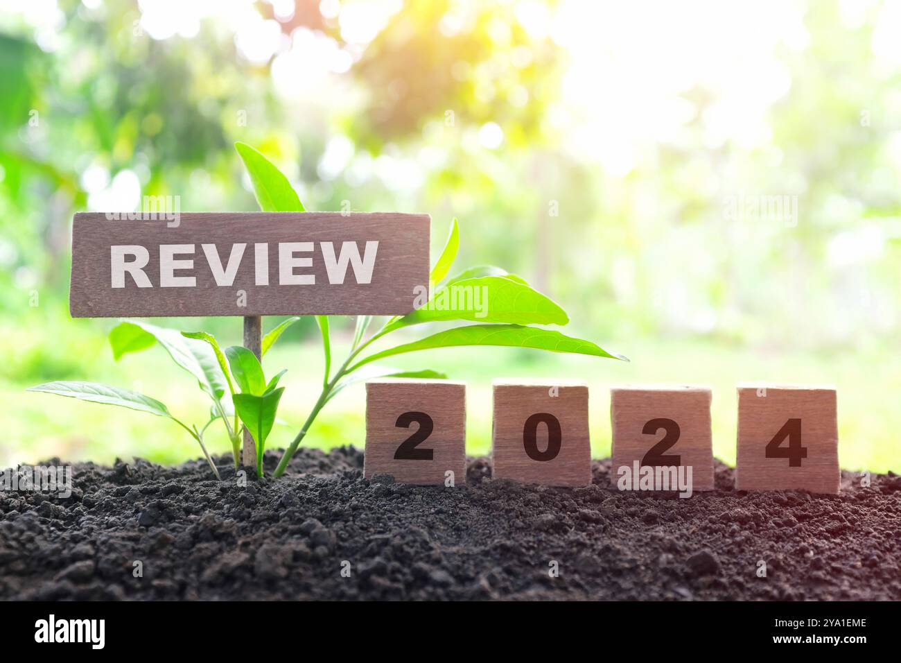 Year end 2024 review and summary concept. Wooden blocks in dark sunset ...