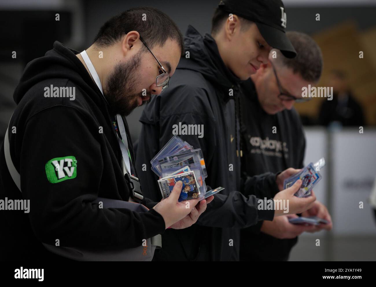 Vancouver, Canada. 11th Oct, 2024. People look at the trading cards ...
