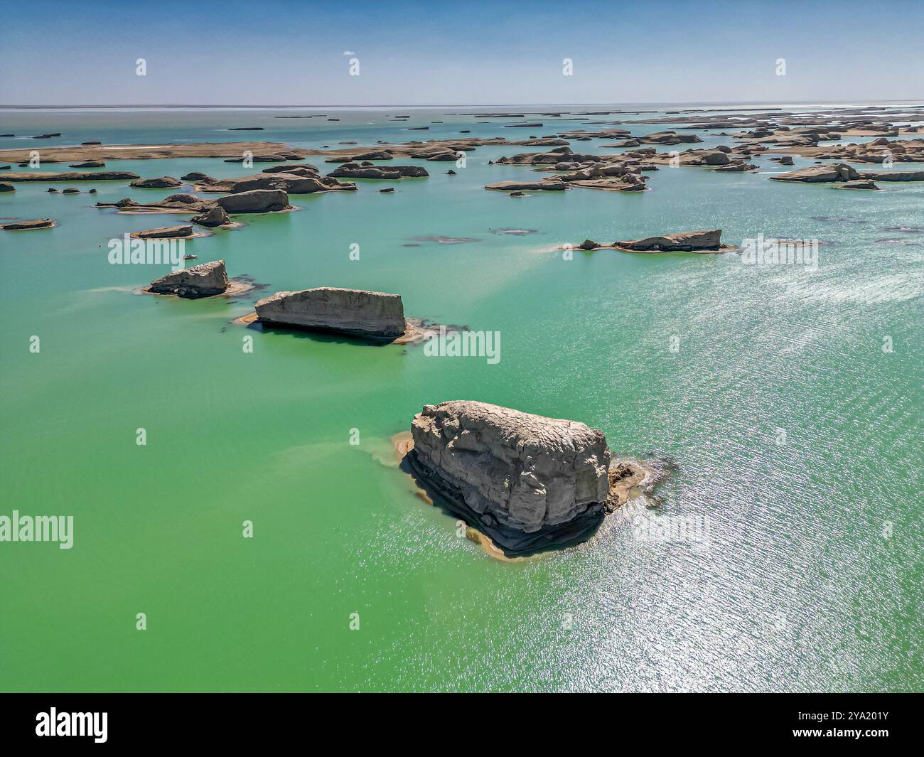 Yardang landforms and reflection in lake. Location: Wusute Aquatic ...