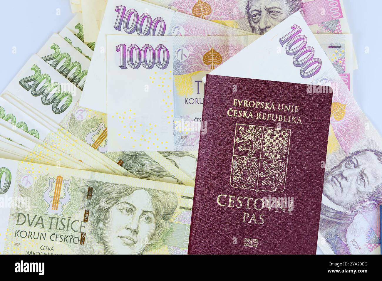 Czech passport with various denominations of CZK koruna banknotes is ...