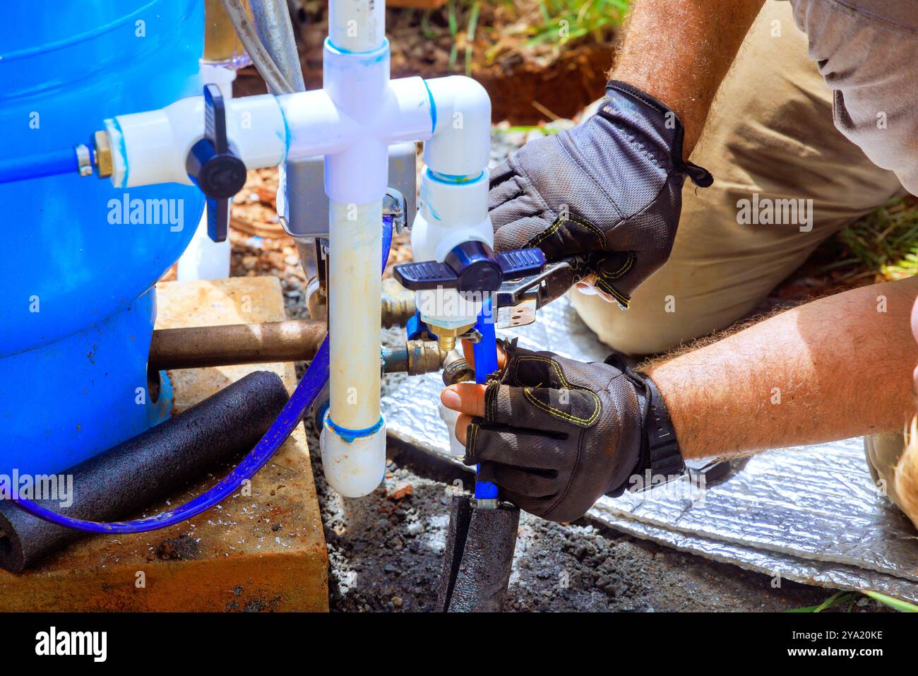 Plumber service assembles connection between water well house water ...