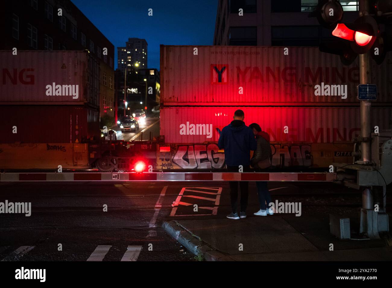 Seattle, USA. 1 Nov, 2023. People at a train crossing on Alaskan Way on ...