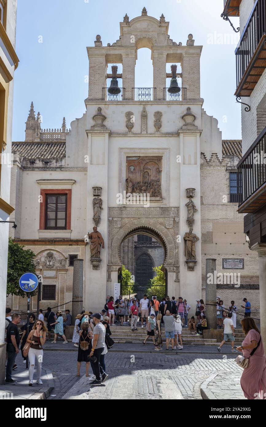 People stream through the entrance of a historic building, surrounded ...
