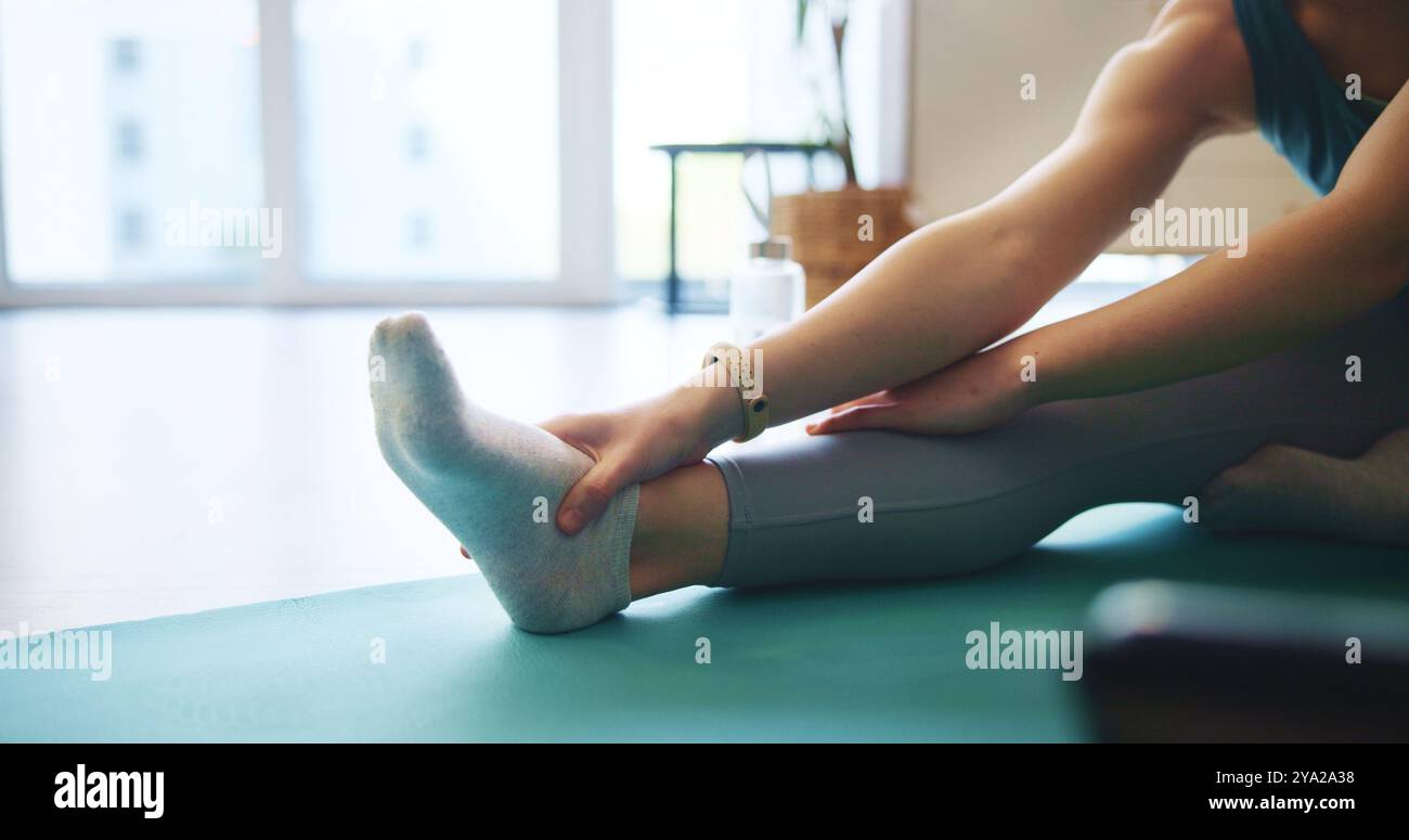 Woman, hands or stretching foot on mat in home for flexibility for ...