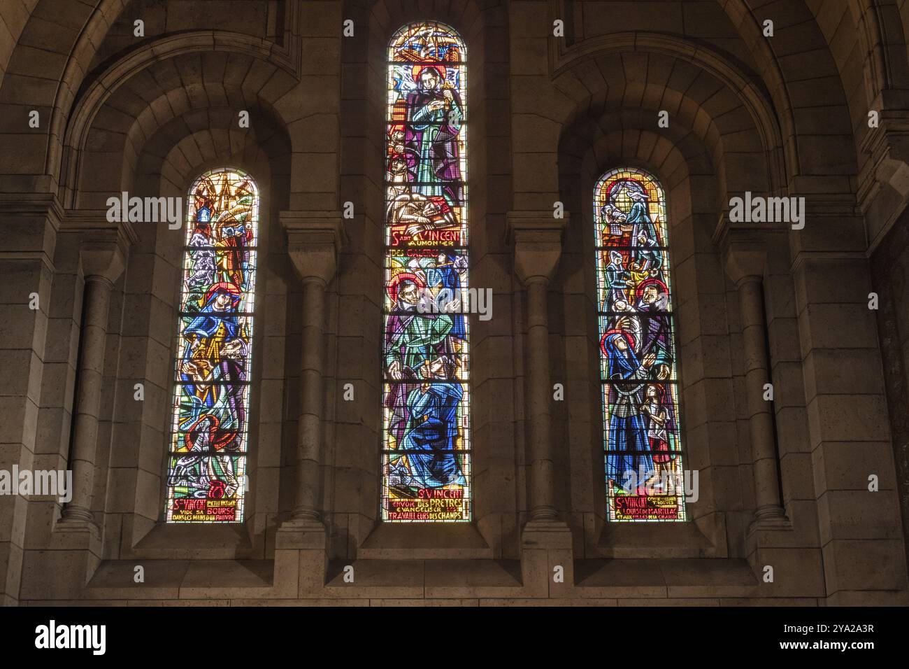 Three stained glass windows in a church, illuminated with various ...