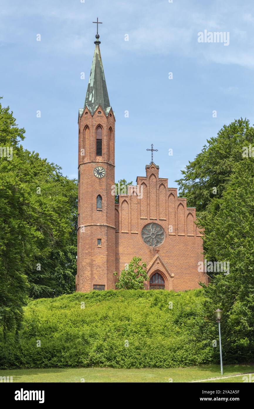 An impressive brick church with tower, embedded in green nature, Ruegen ...