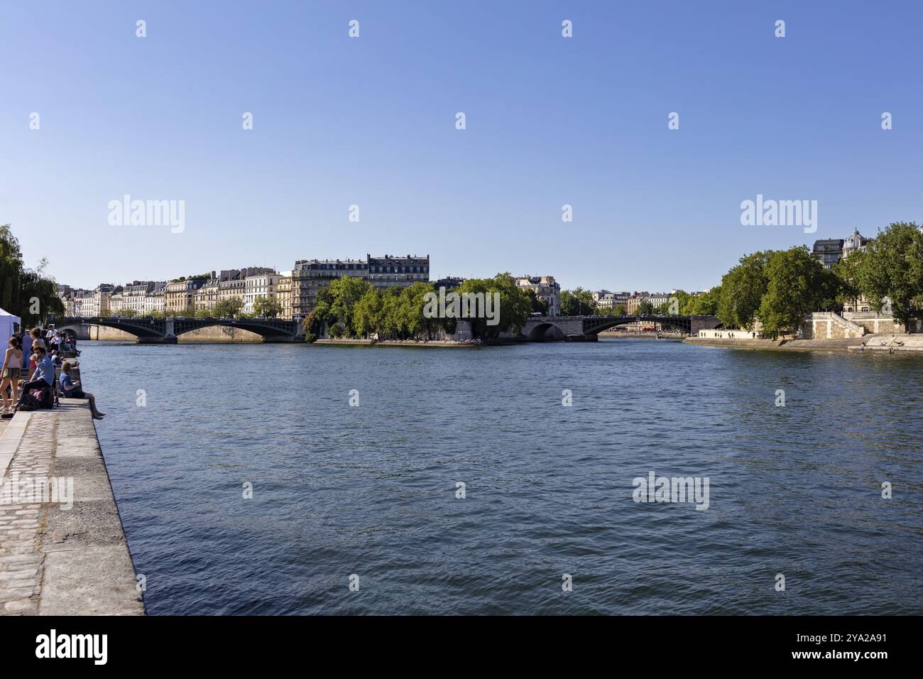 Riverbank with a view of a bridge and neighbouring buildings, Paris ...