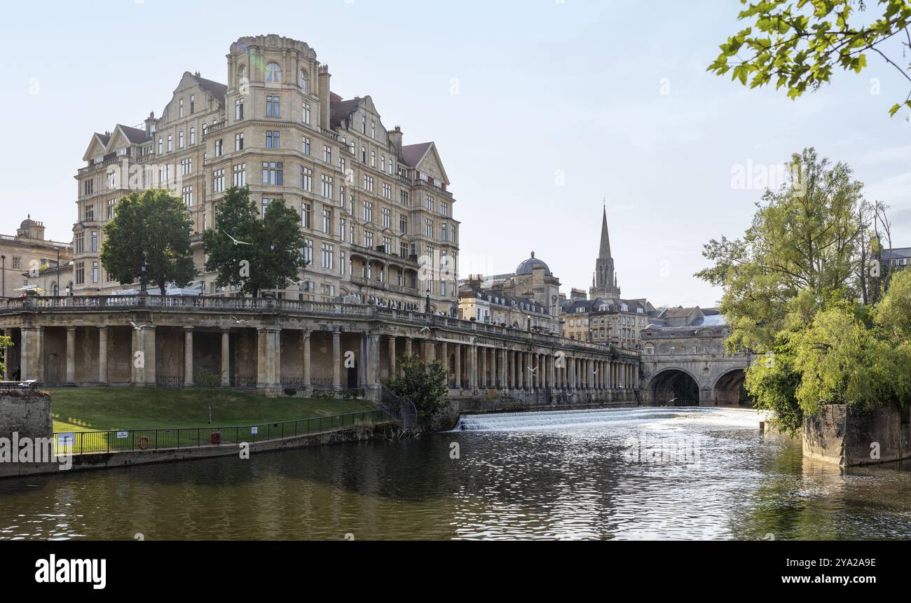 Large historic building and riverside church with clear skies, Bath ...