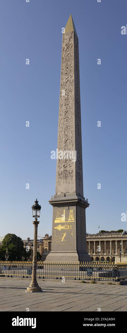 Towering obelisk with ancient symbols, next to a street lamp, Paris ...
