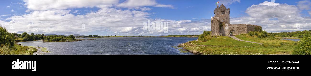 Panoramic view of a medieval castle on a river with clouds in the sky ...