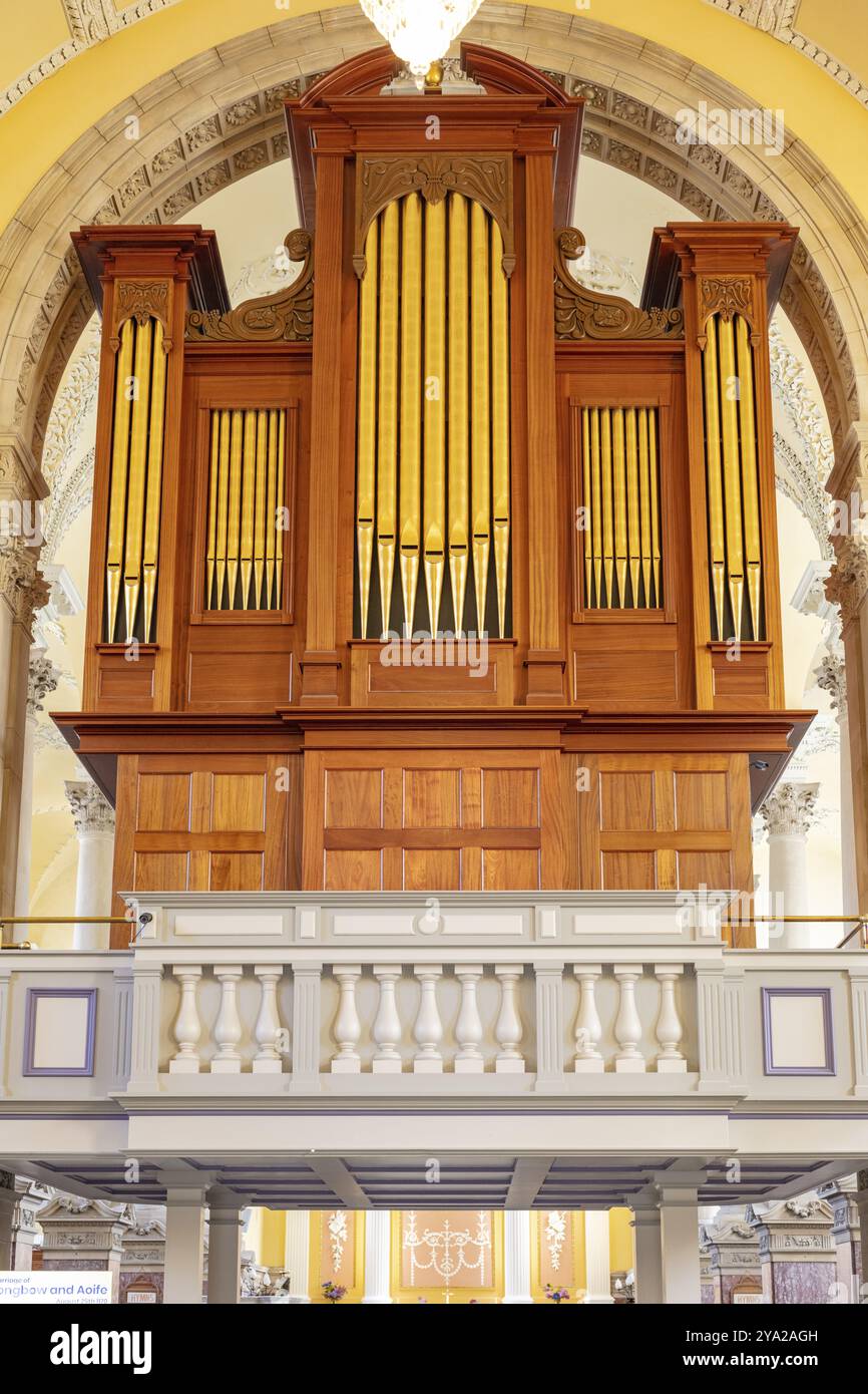 Large wooden organ with golden pipes in a church, Waterford Stock Photo ...