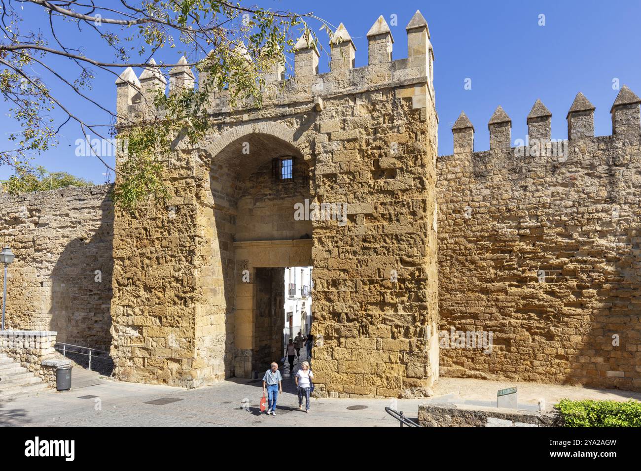 Massive historic city gate made of stone with people passing by in ...