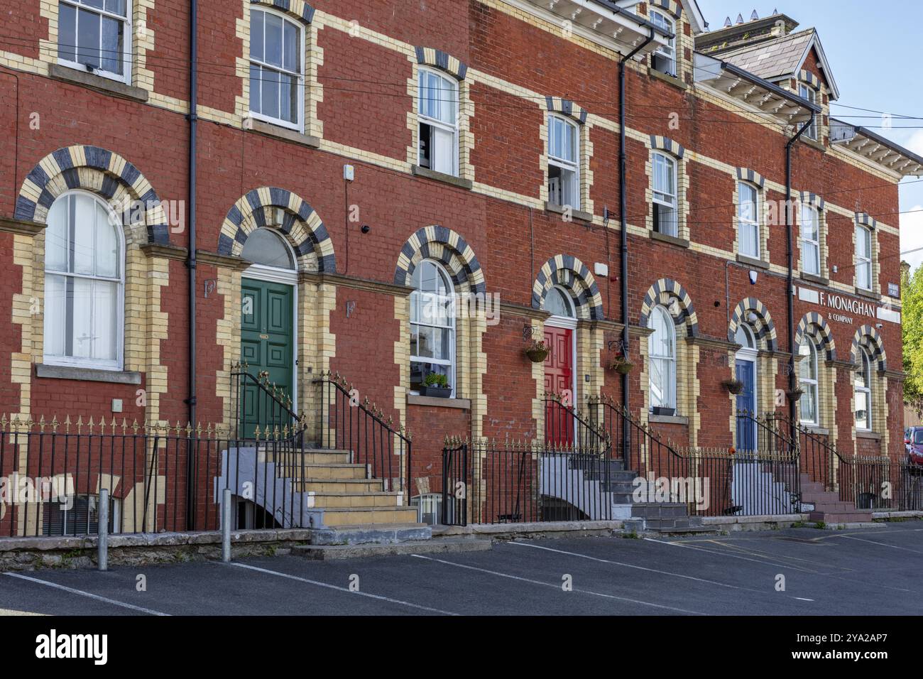 Rows of historic brick houses with colourful doors and ornate brick ...