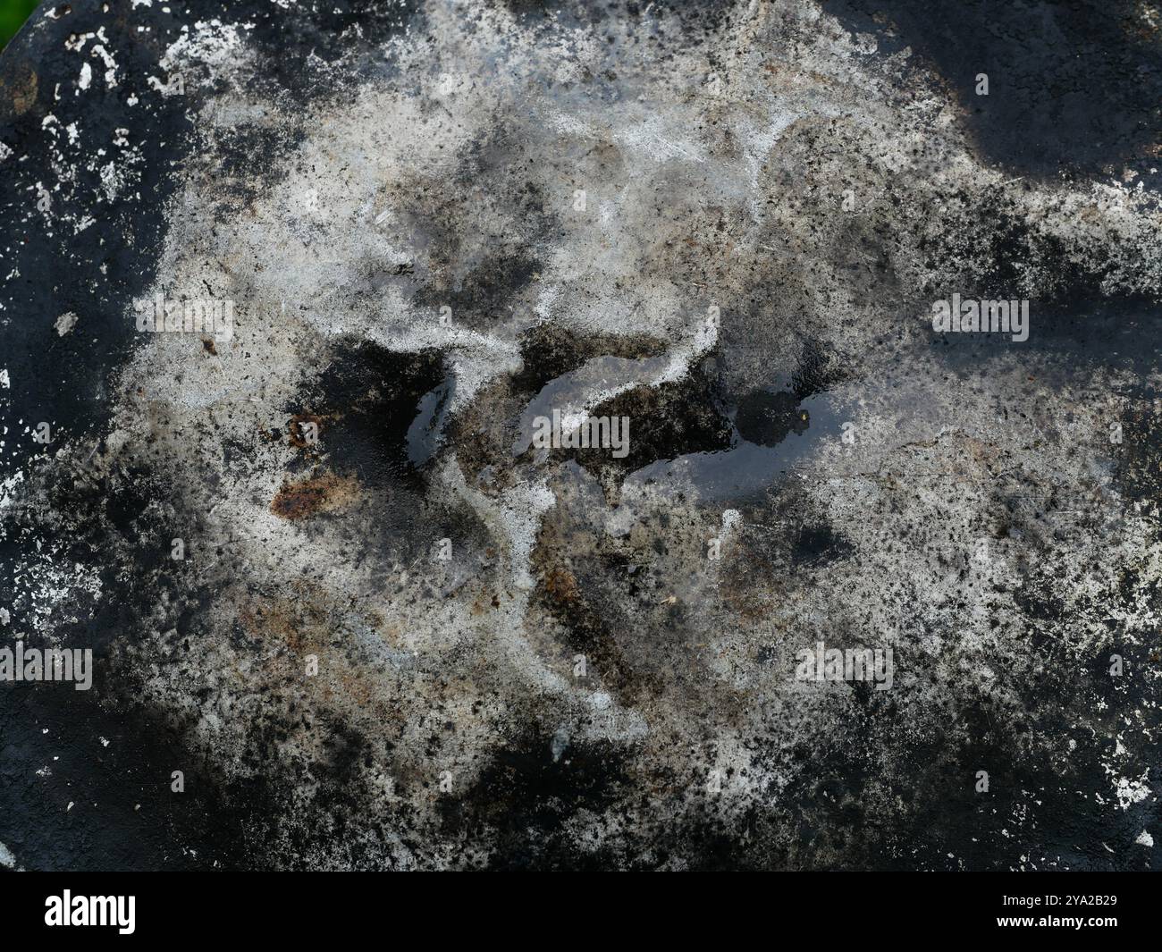 Brown and black color stains on silver surface that has white scratch ...