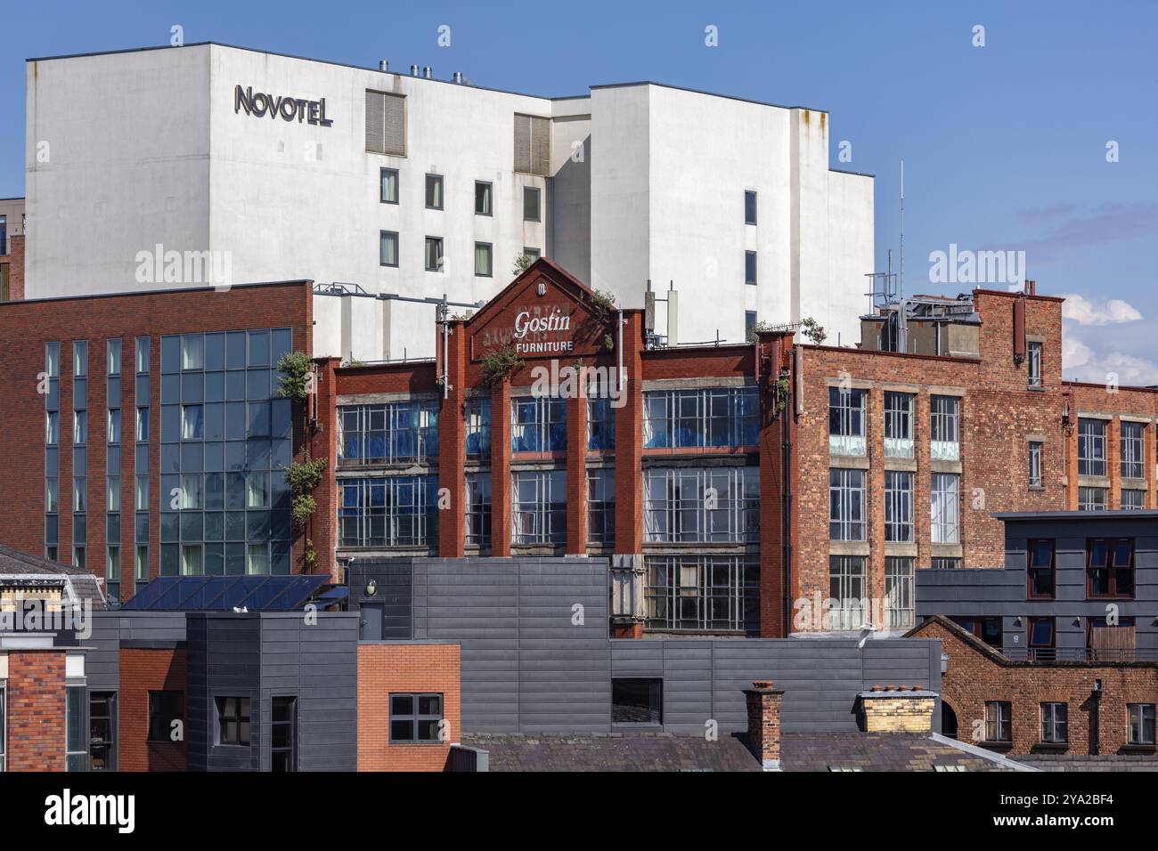 Modern building complex with red brick elements under a clear sky ...