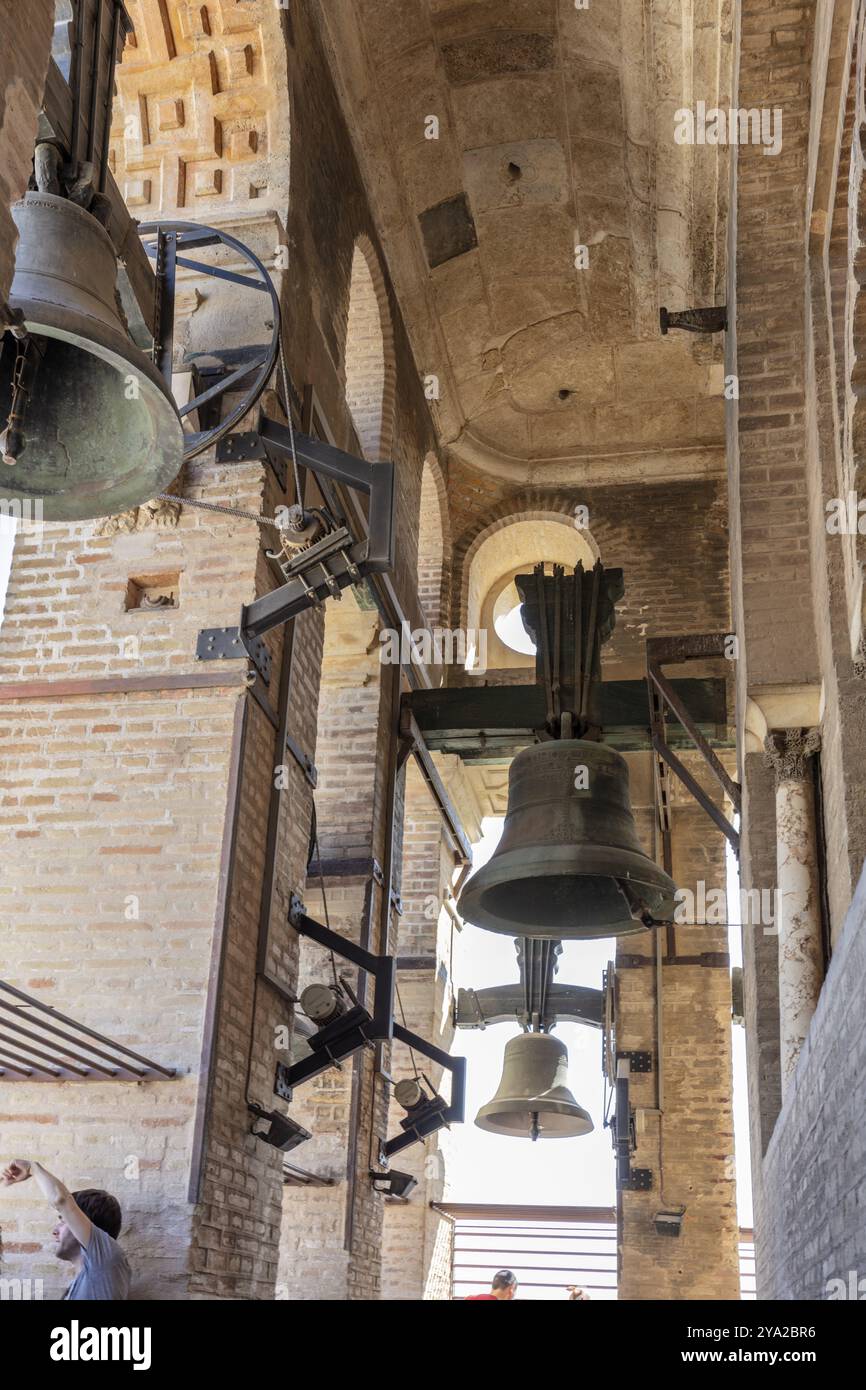 View into a historic bell tower with large bells and old brick walls ...