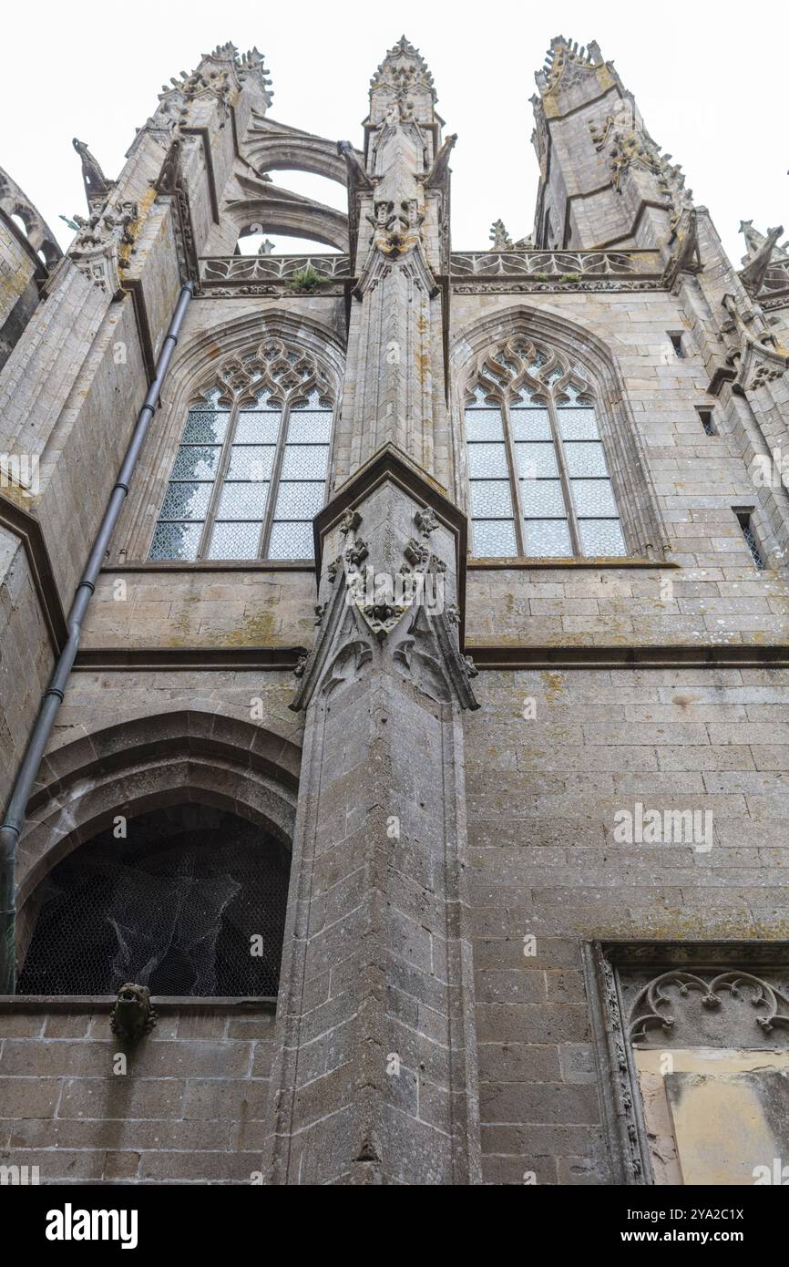 Detail of a Gothic church structure with richly decorated windows and ...
