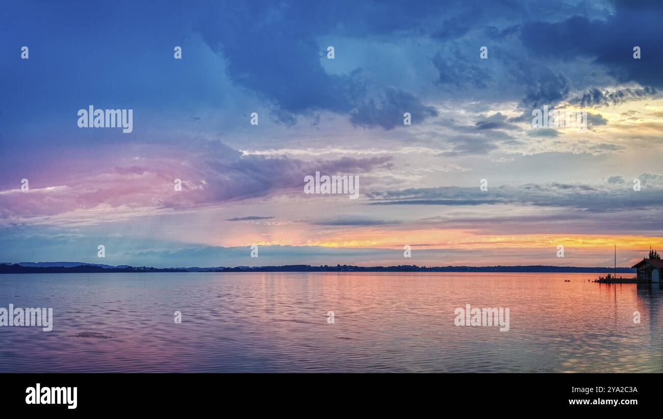 A calm lake at sunset with blue and pink colours in the sky, Uebersee ...