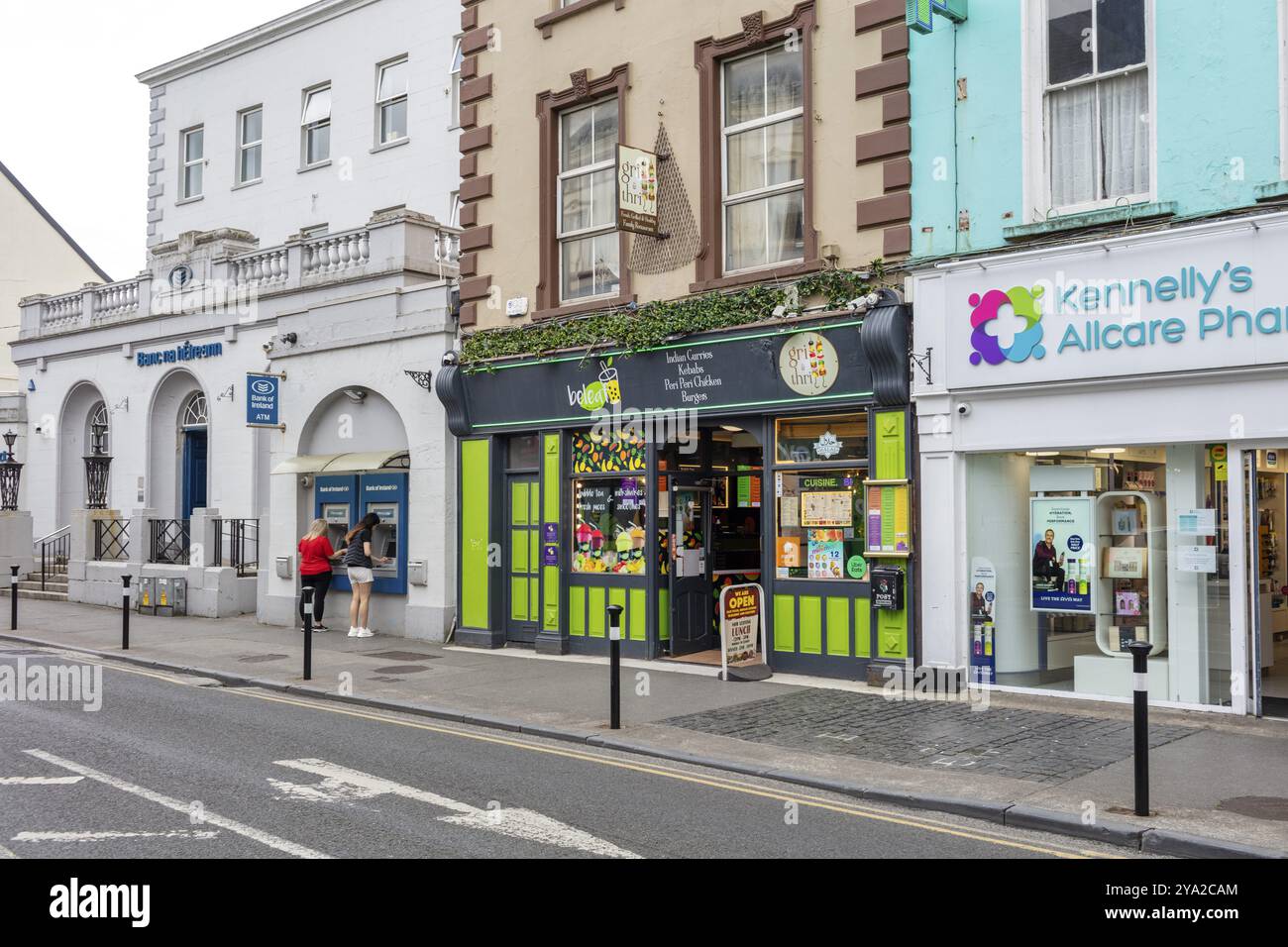 Shops and pharmacy along a busy street with mixed historic and modern ...