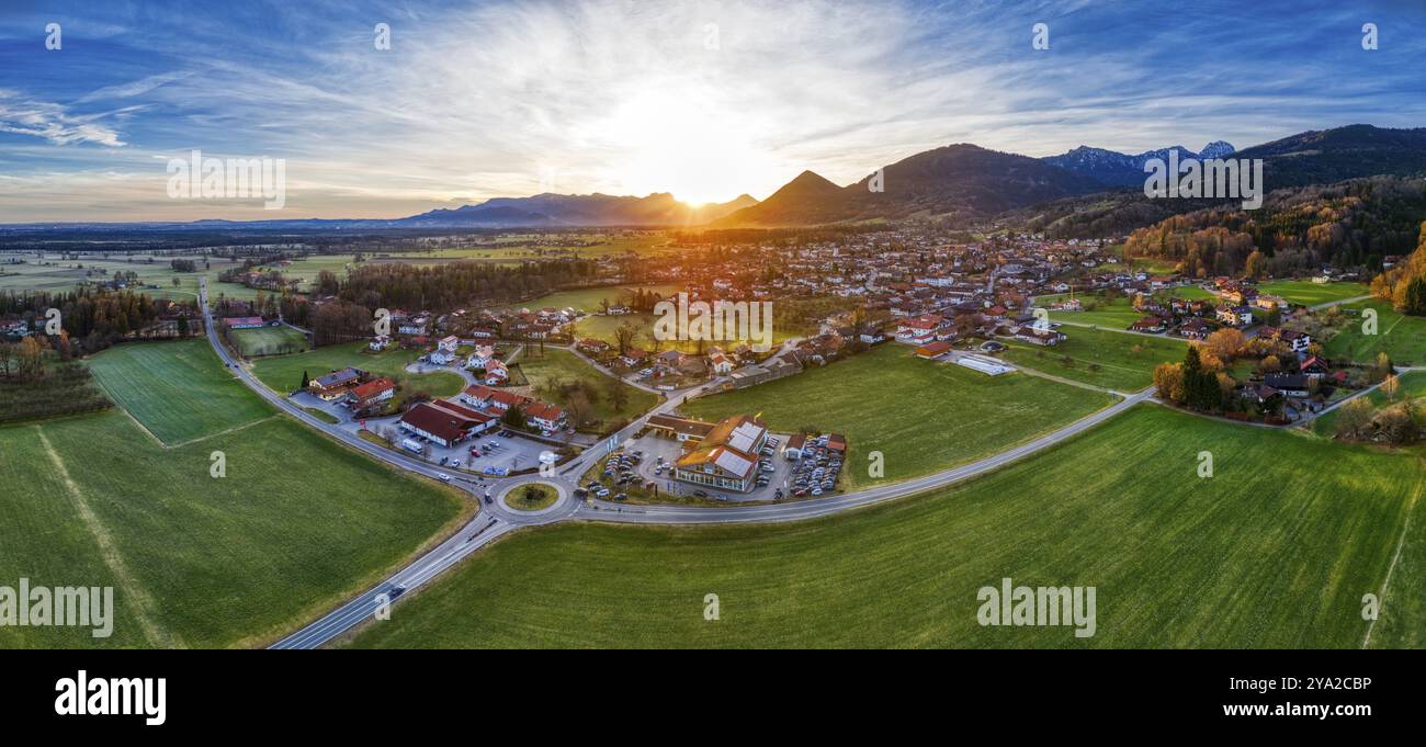 Aerial view of a village in an expansive landscape at sunset ...