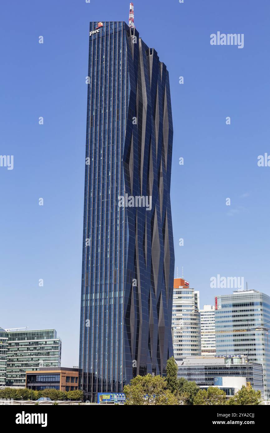Modern high-rise building with geometric facade against a blue sky ...