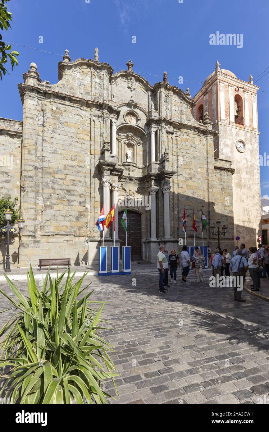 Historic church with lively square and flags under a blue sky, Tarifa ...