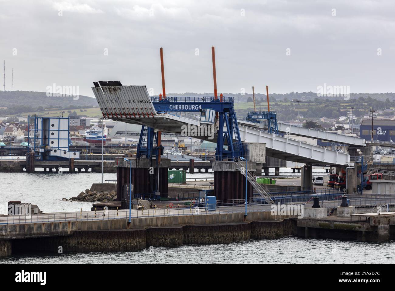 A mechanical bridge raised in an industrial harbour to allow navigation ...