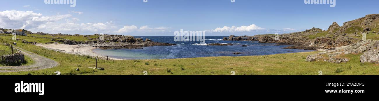 Coastal landscape with rocks and calm sea, surrounded by meadows, Malin ...
