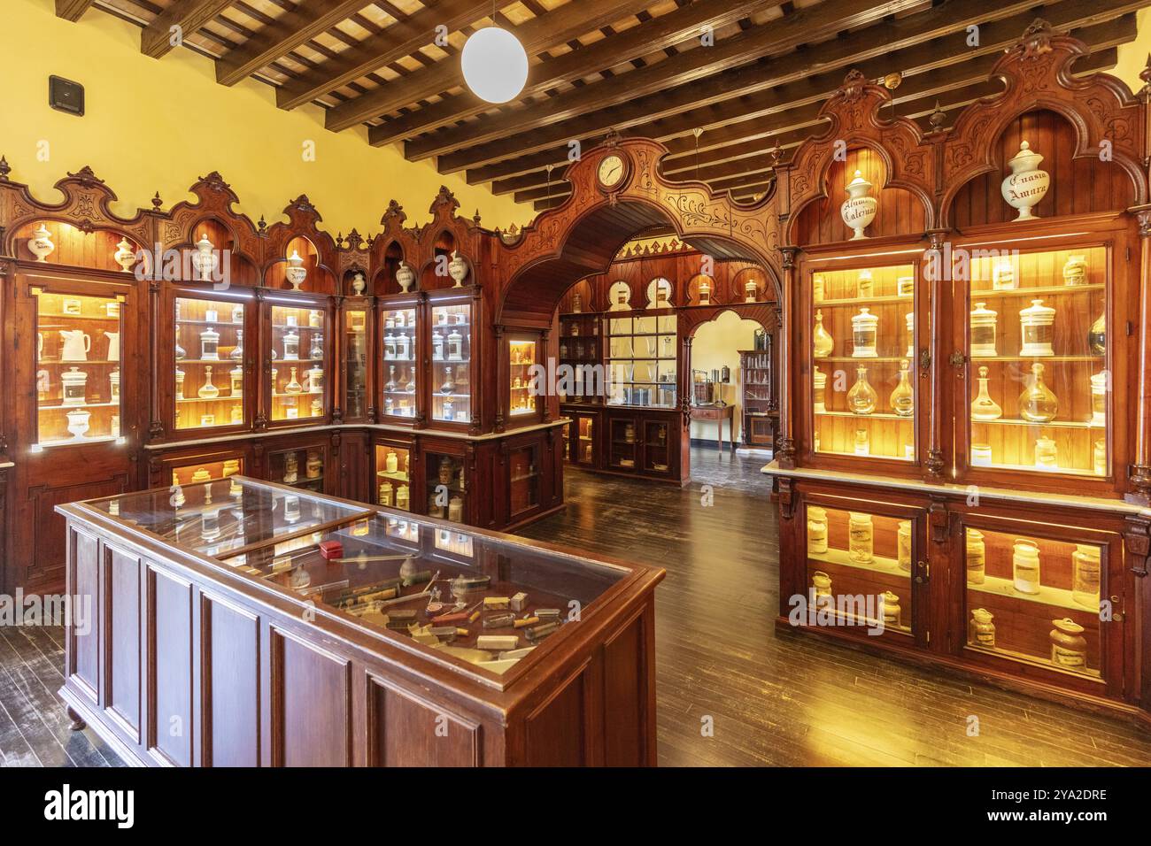 Traditional pharmacy interior with illuminated glass cabinets and ...