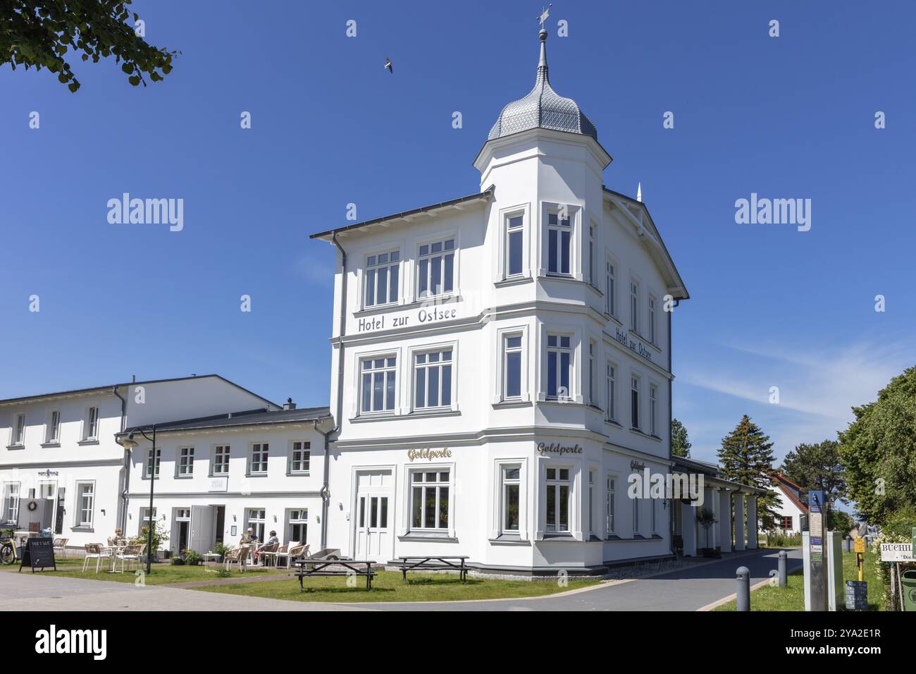 An impressive historic hotel in white style under a clear blue sky ...