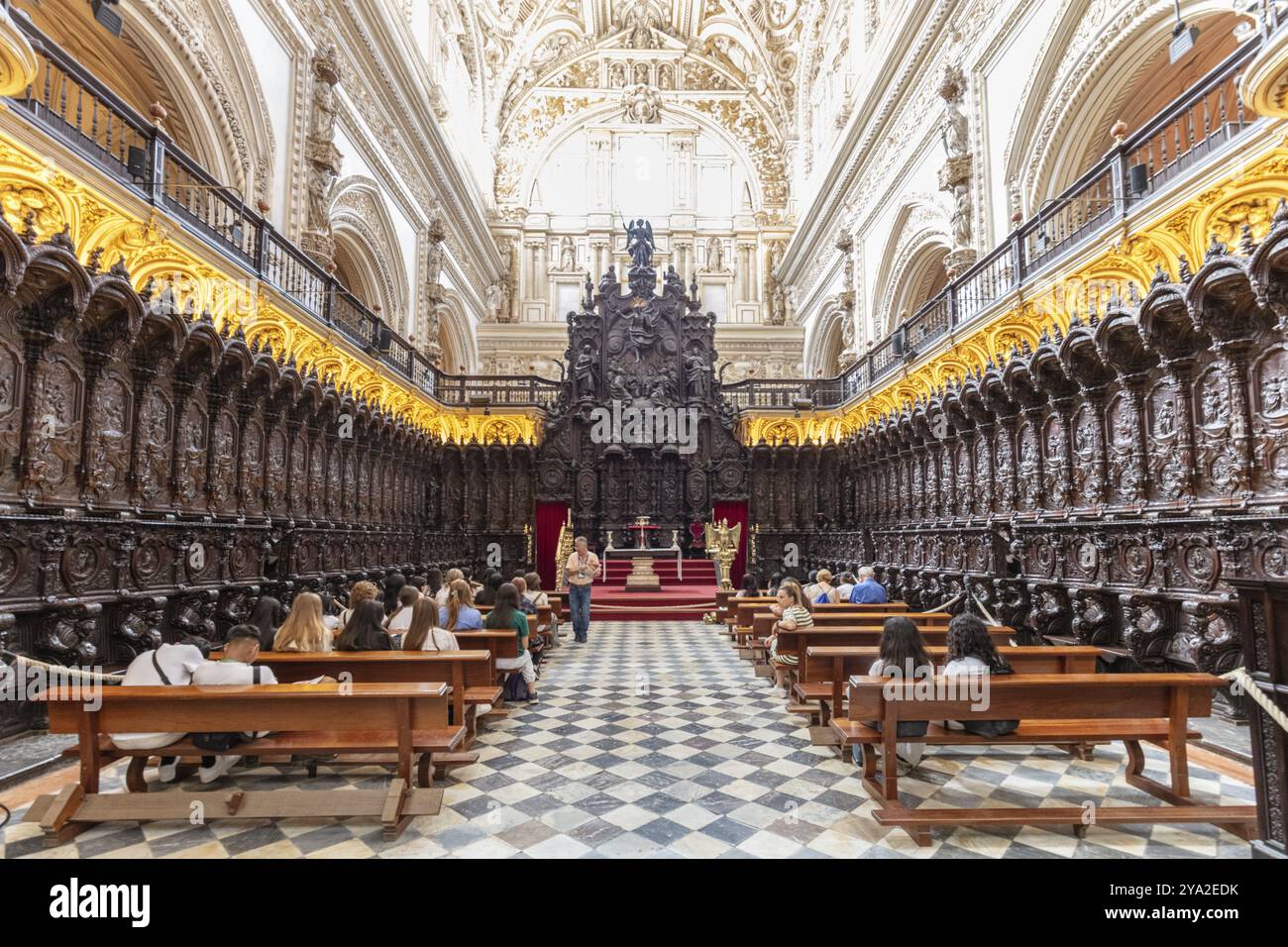 Impressive church interior with carved wooden choir benches and group ...