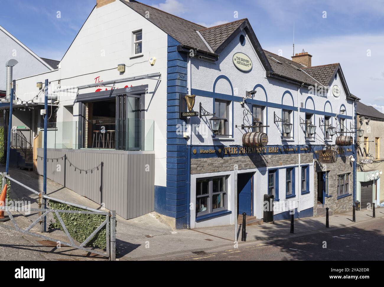 Traditional pub with blue and white facade and signs in an urban ...