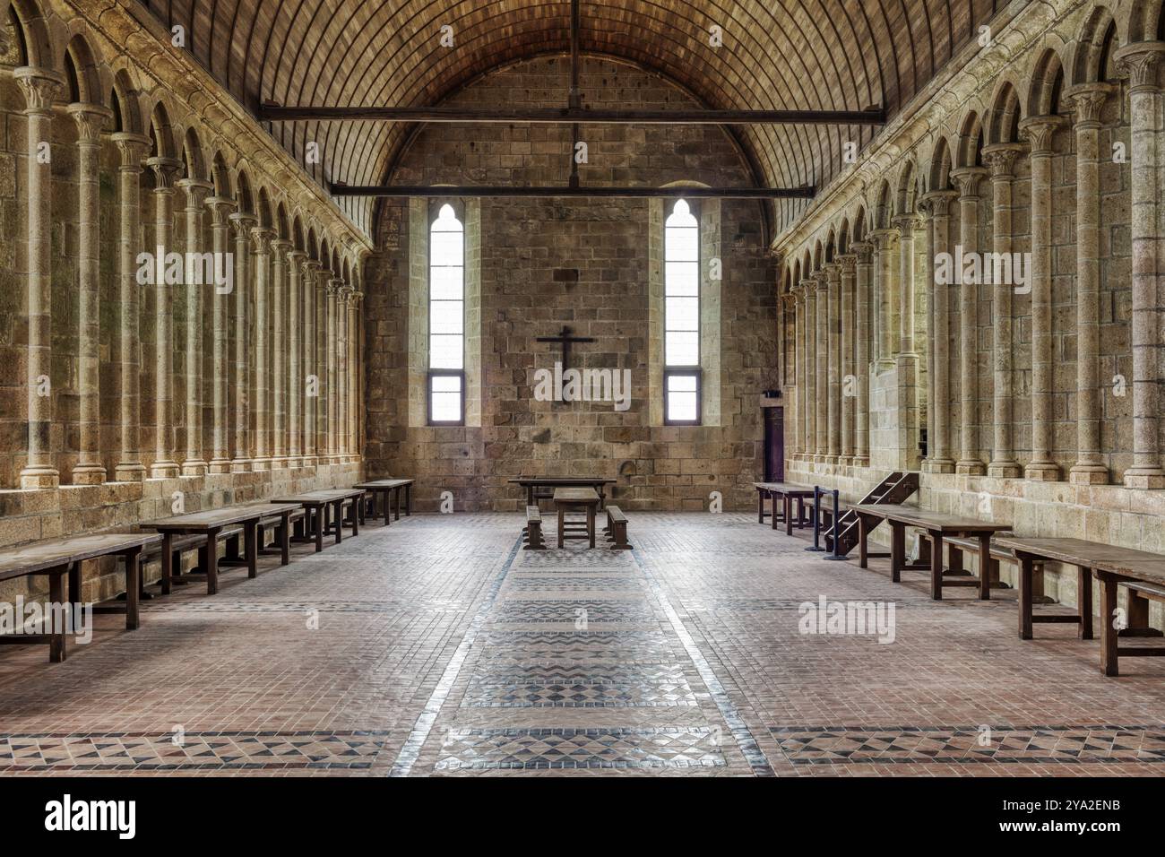 A quiet monastery room with stone arches, tables and high windows, Le ...