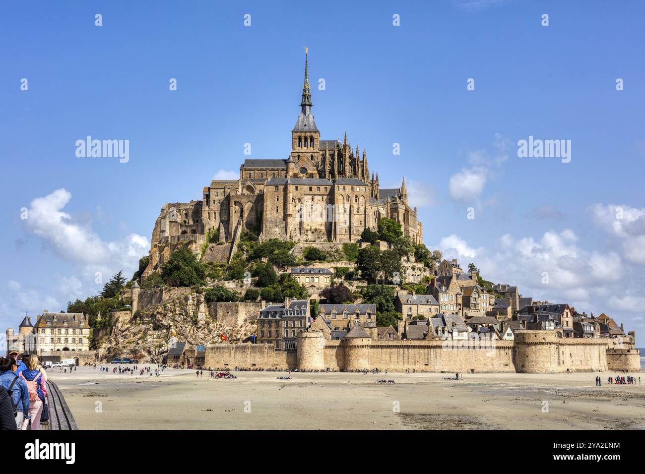 Famous French monastery on an island surrounded by sand under a blue ...