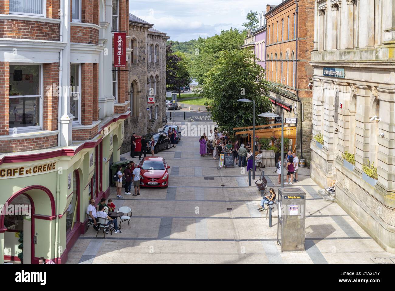 Lively pedestrianised area with cafes and shops, lined with red brick ...