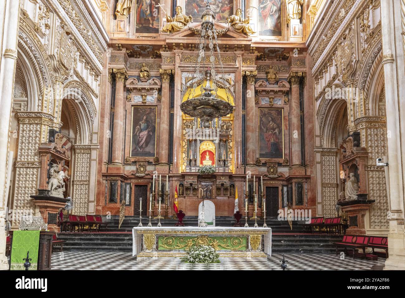 Magnificent baroque altar in a cathedral with ornate paintings and decorations, Cordoba Stock ...