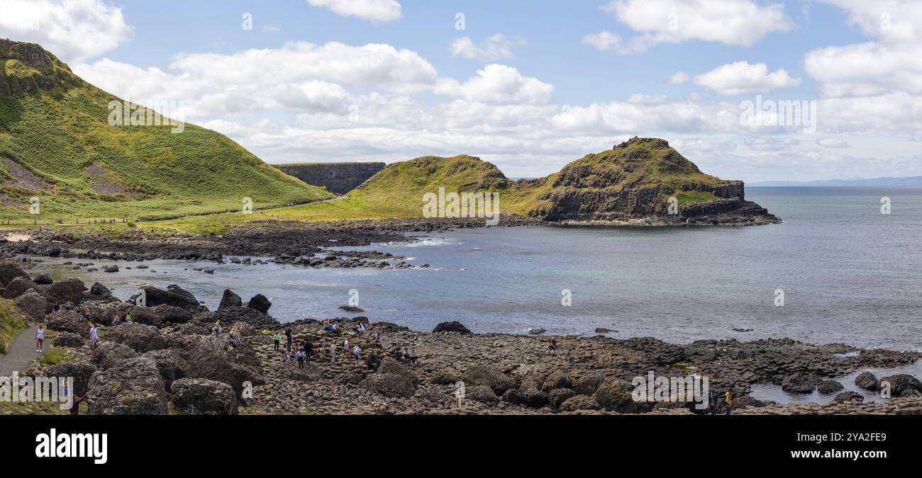 Coastal landscape with green cliffs and rocks by the sea under a blue ...