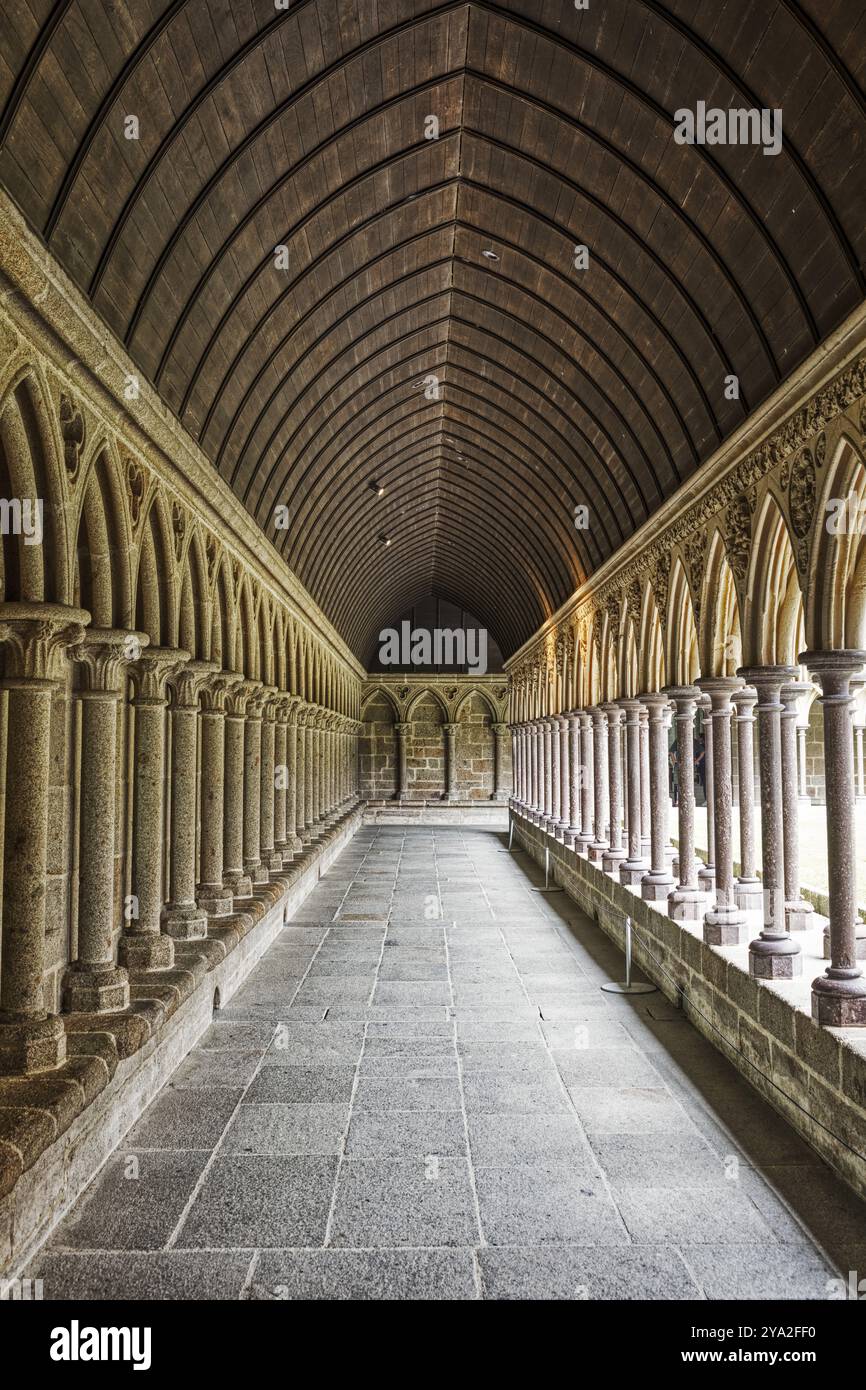 Long cloister with vaulted ceiling and elegant stone arches, Le Mont ...