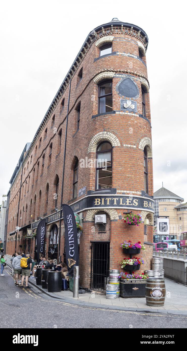 A striking triangular brick building with a pub on the ground floor ...