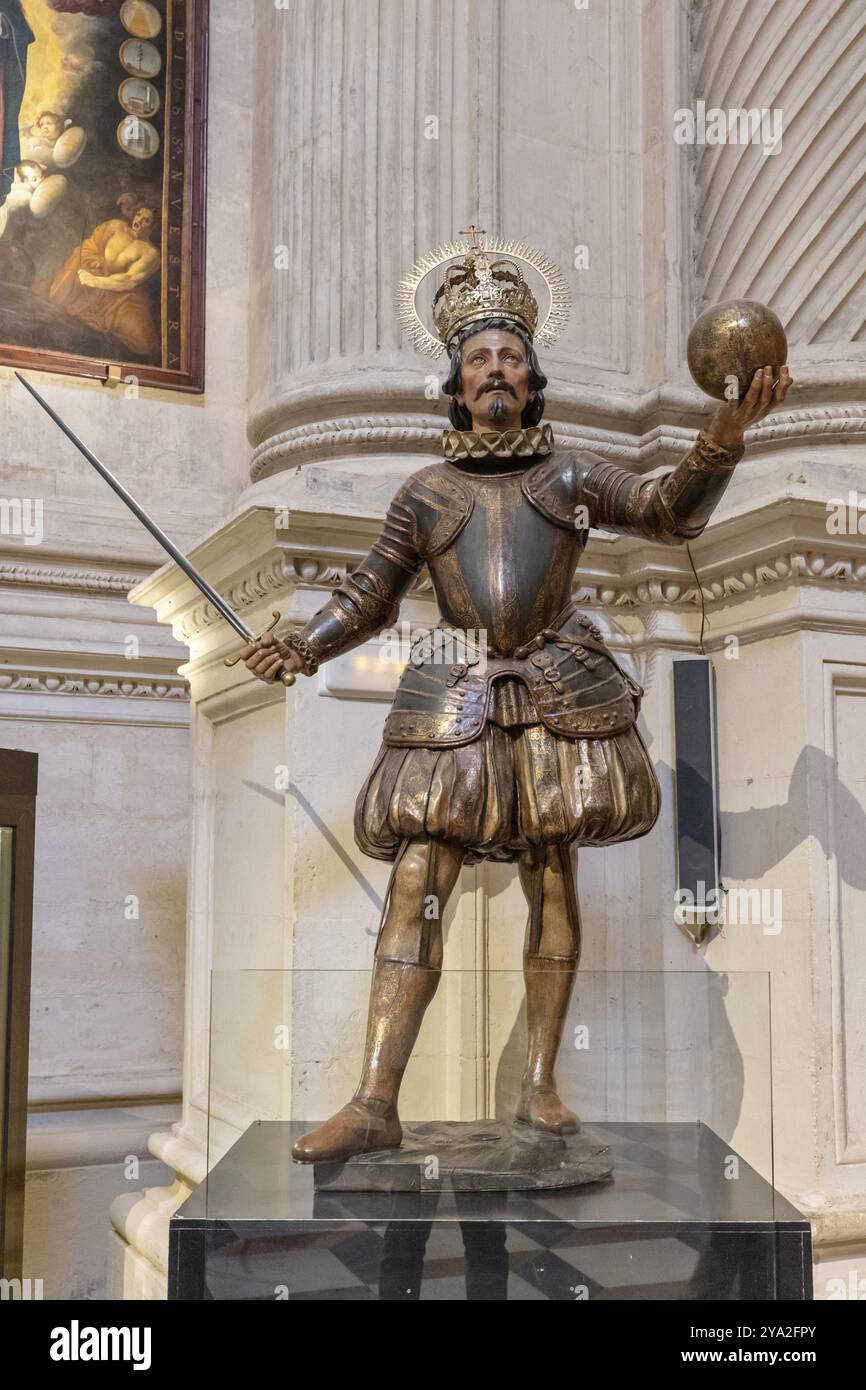 Decorative knight statue with crown and sword in a church, Seville ...