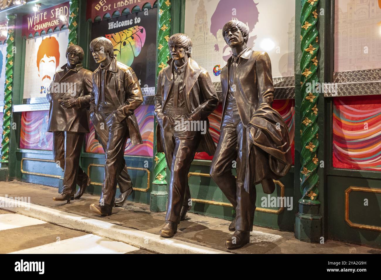 Four bronze statues depict people in motion in front of a decorated ...