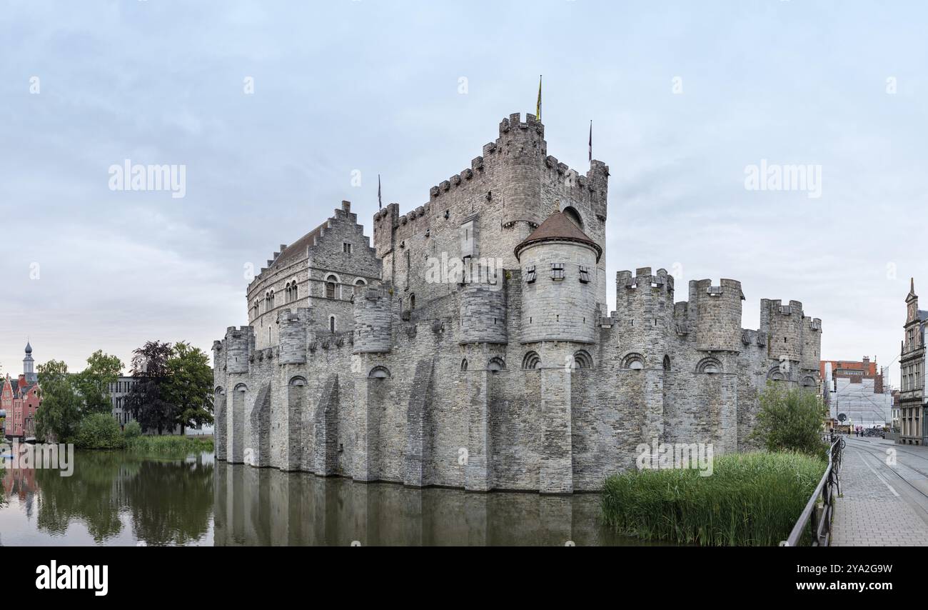 Historic castle with robust walls on the banks of a river under a ...