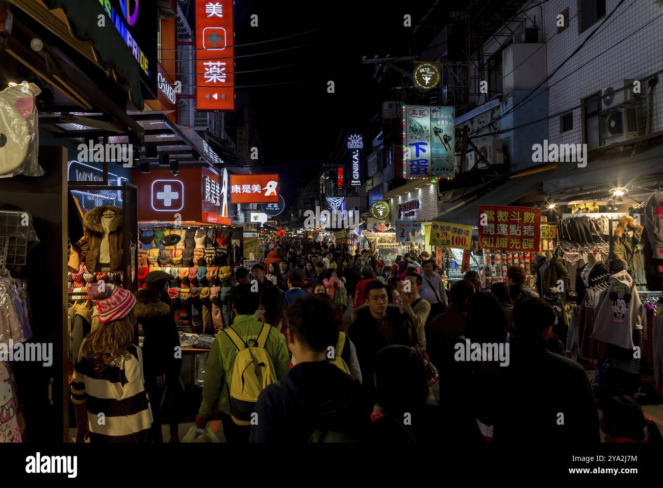 Taipei, Taiwan, January 04, 2015: Alley full of people at the night market in Shilin district ...