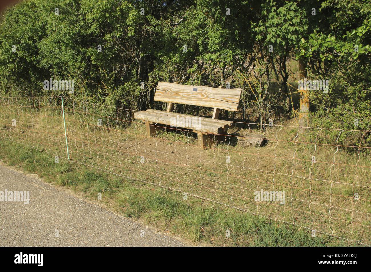 Bench on a path is not accessible due to a fence Stock Photo - Alamy