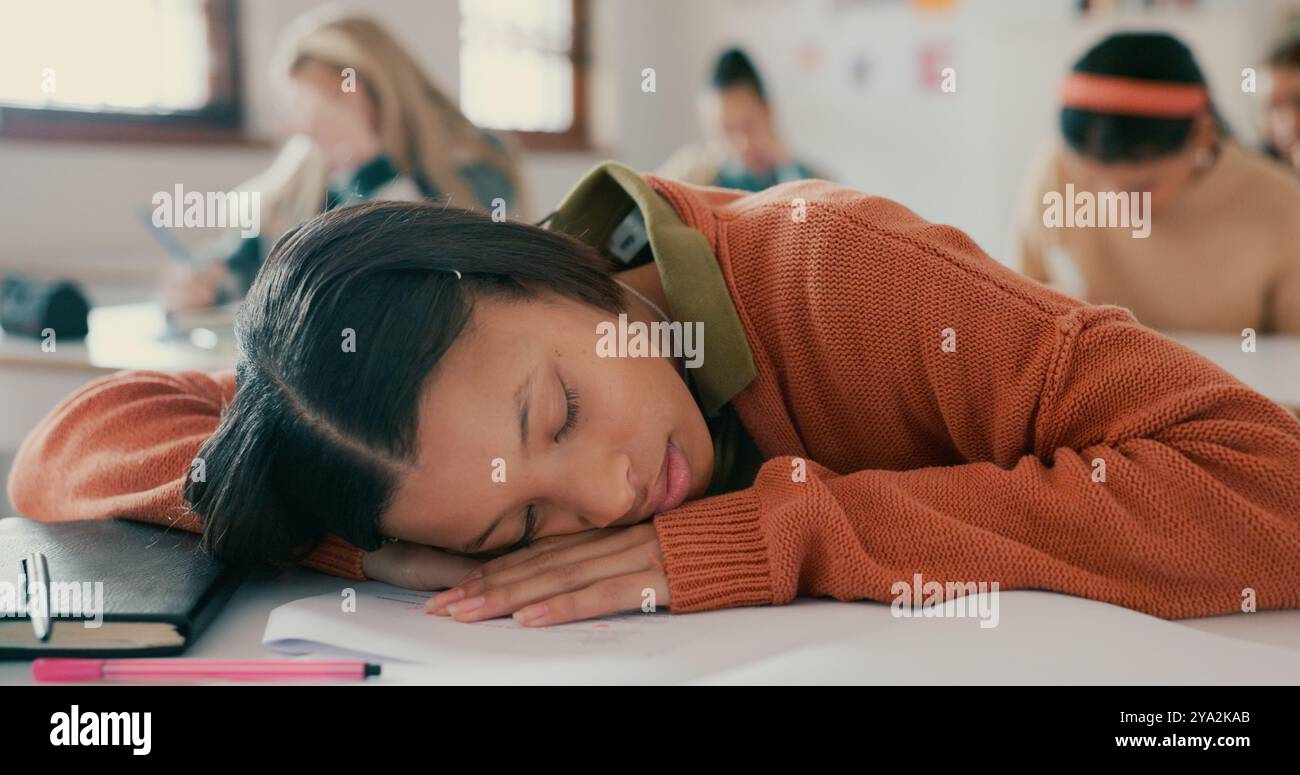 Tired, sleeping and girl on desk in classroom at school with fatigue in ...