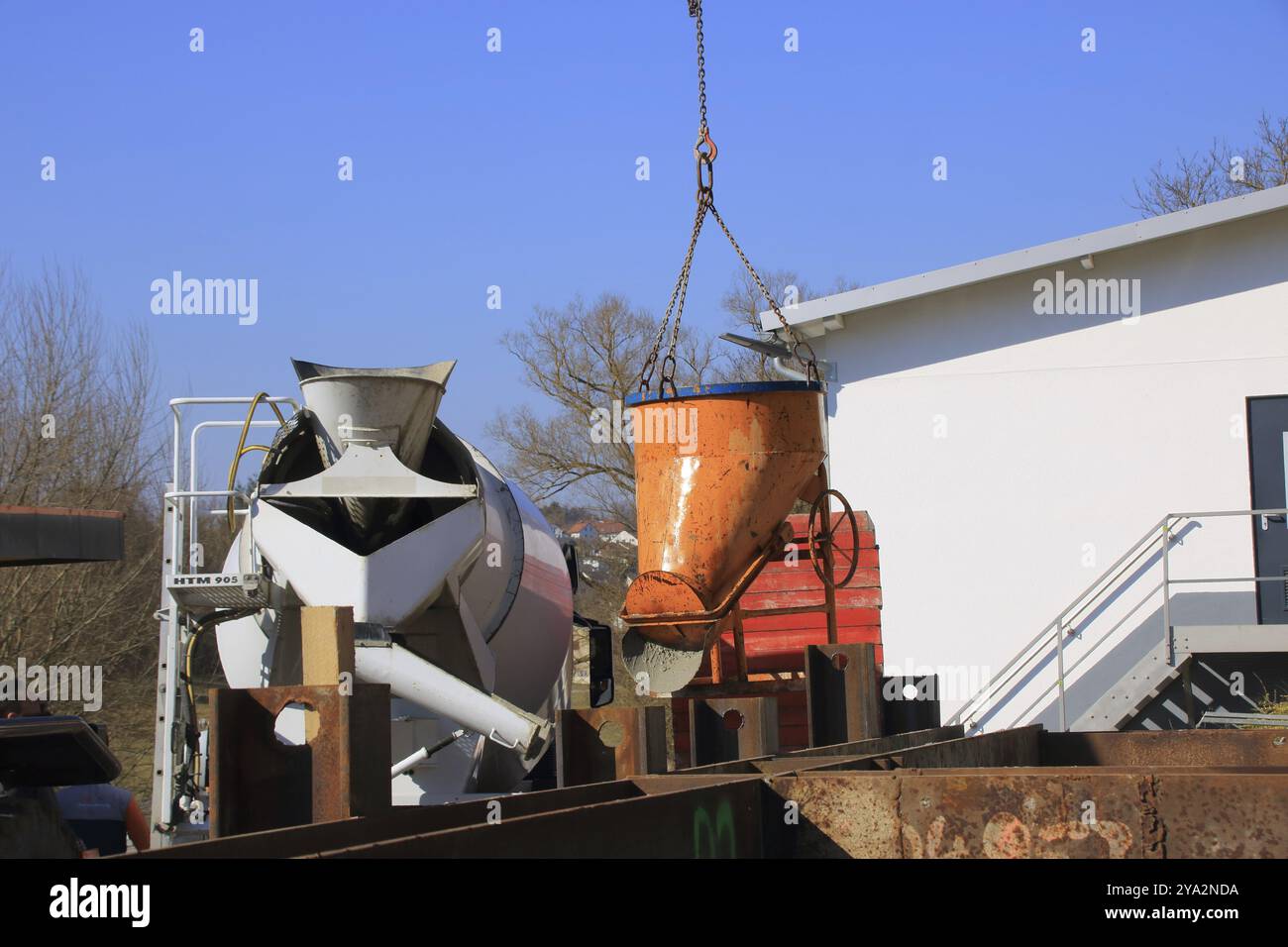 Transport of liquid concrete on a construction site through a concrete ...