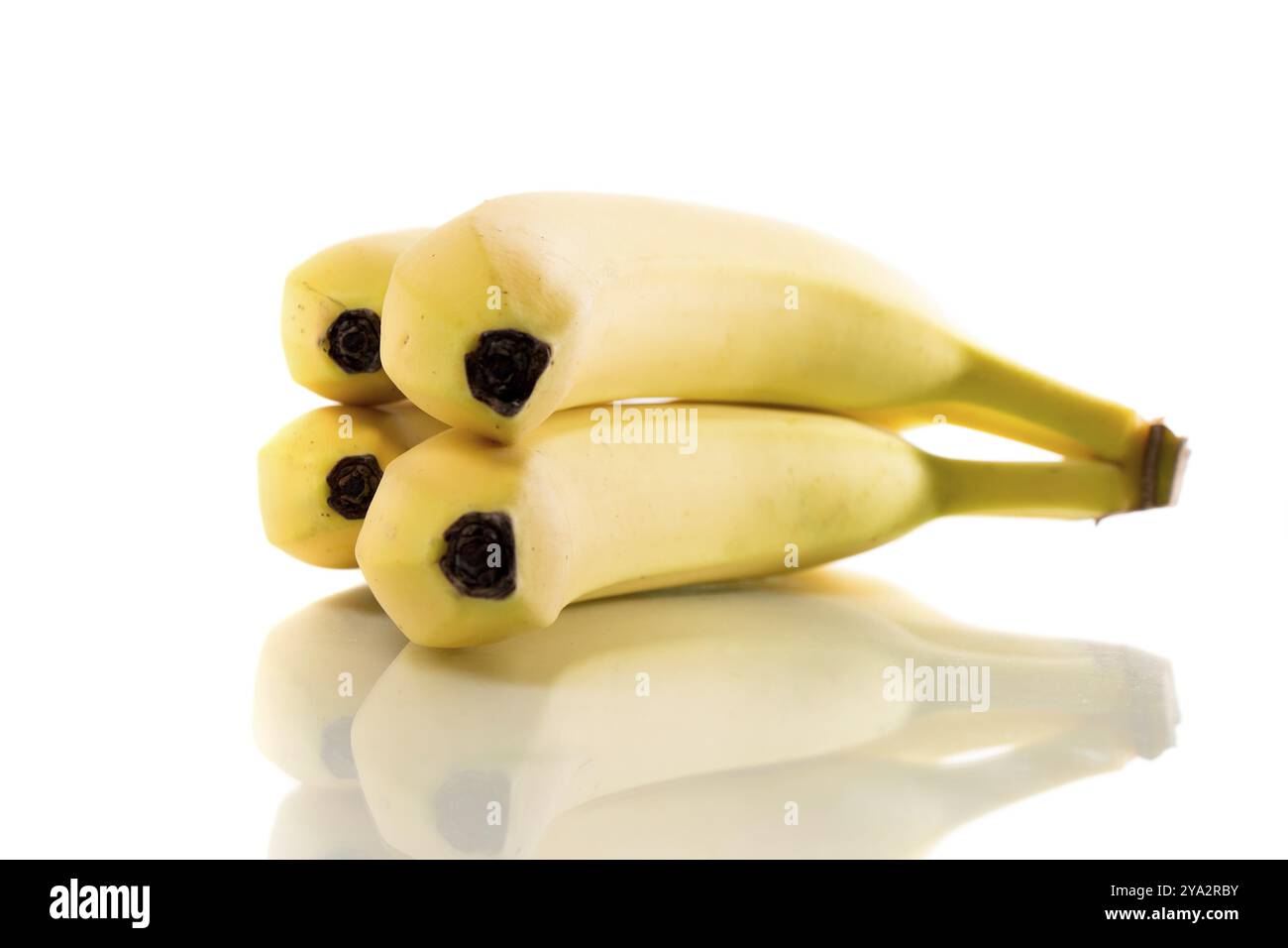 Four bananas on a white background Stock Photo - Alamy